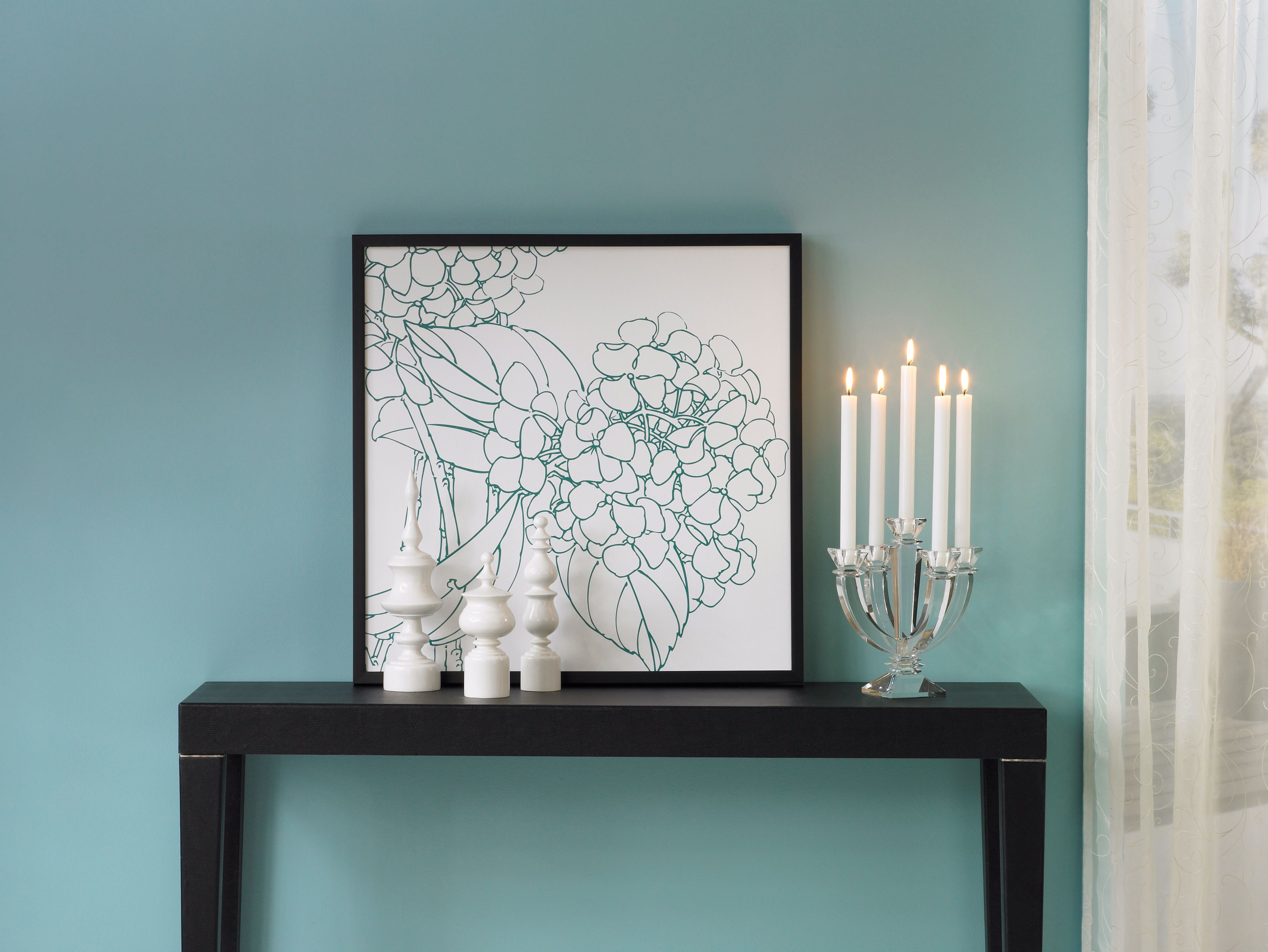 A contemporary hallway with light accents on a shagreen console table ...